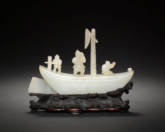 Bonhams : A green jade boat with rudder, mast and three sailors
