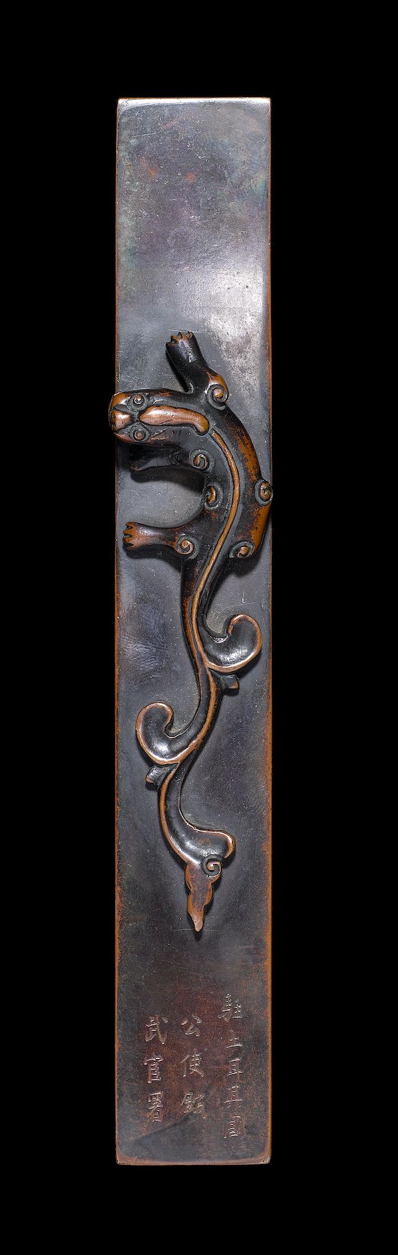 Bonhams : A bronze scroll weight of rectangular form
