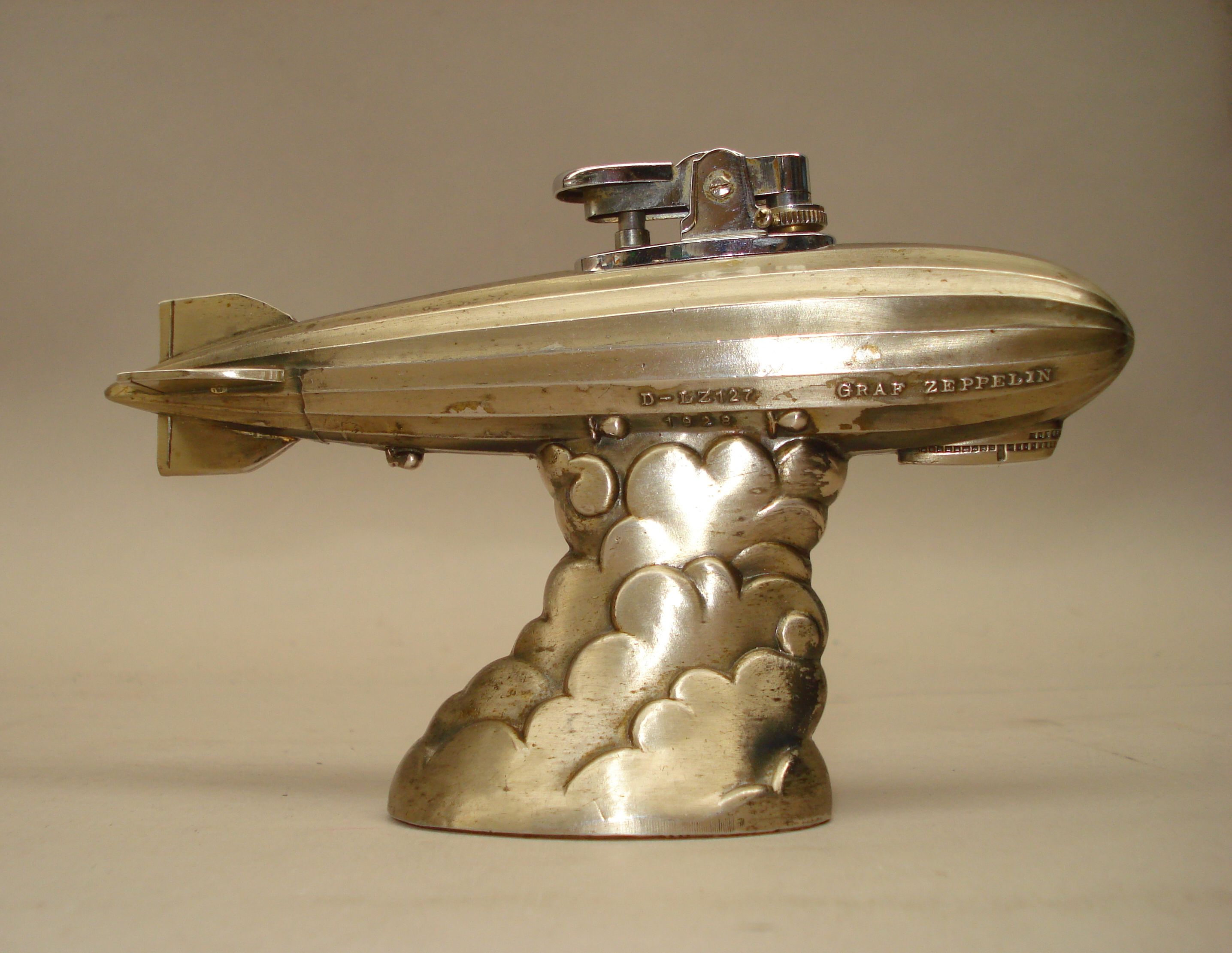 Bonhams Cars : A souvenir cigarette lighter mounted within a model of ...