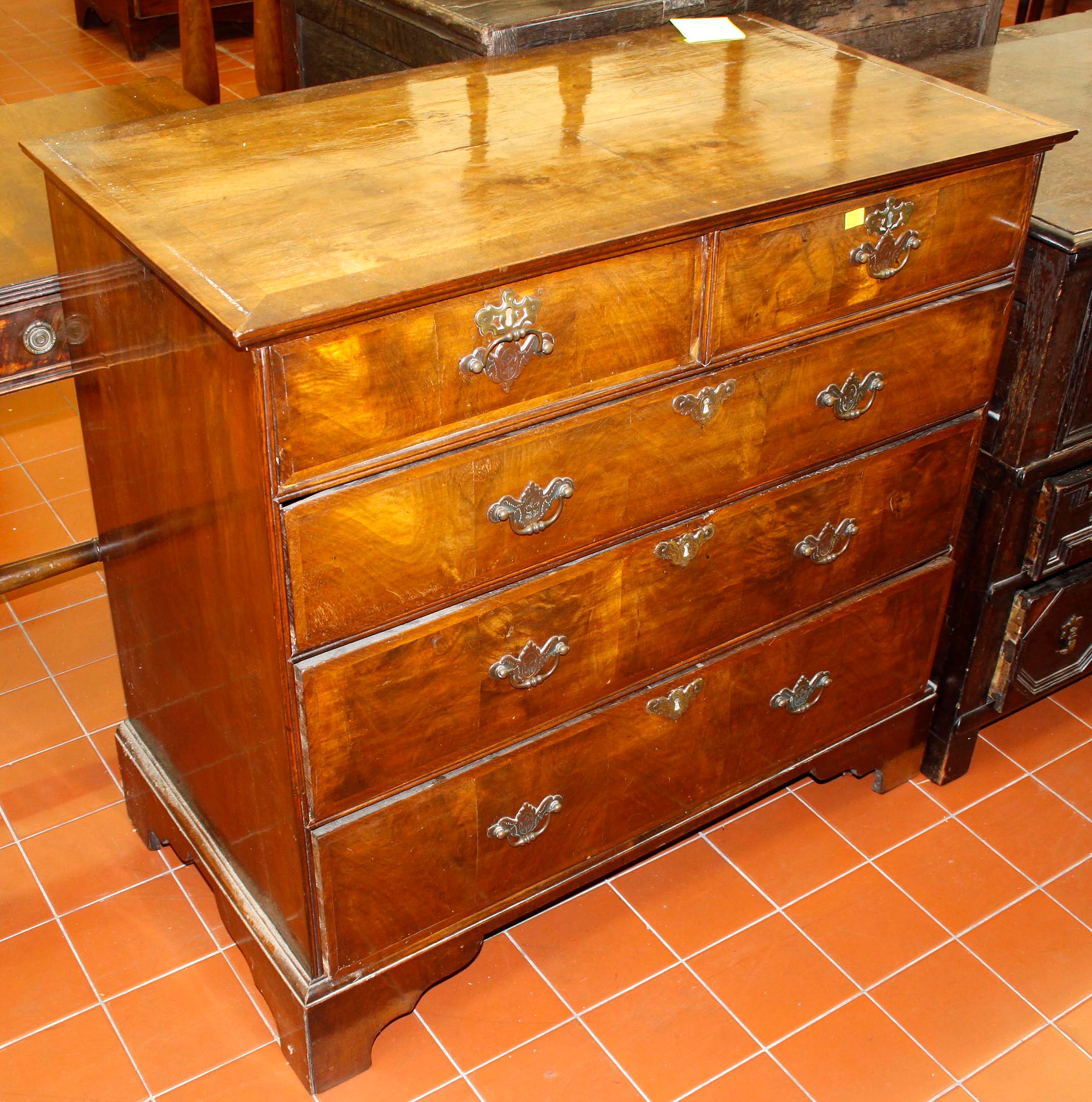 Bonhams : A walnut veneered chest,of two short and three long drawers on bracket feet, 92cm wide