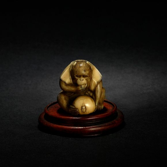 Bonhams : A Japanese netsuke of a monkey examining an insect on a melon ...