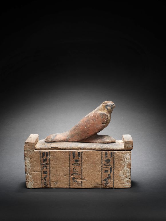 Bonhams : An Egyptian wood model coffin an Egyptian wood Horus falcon ...