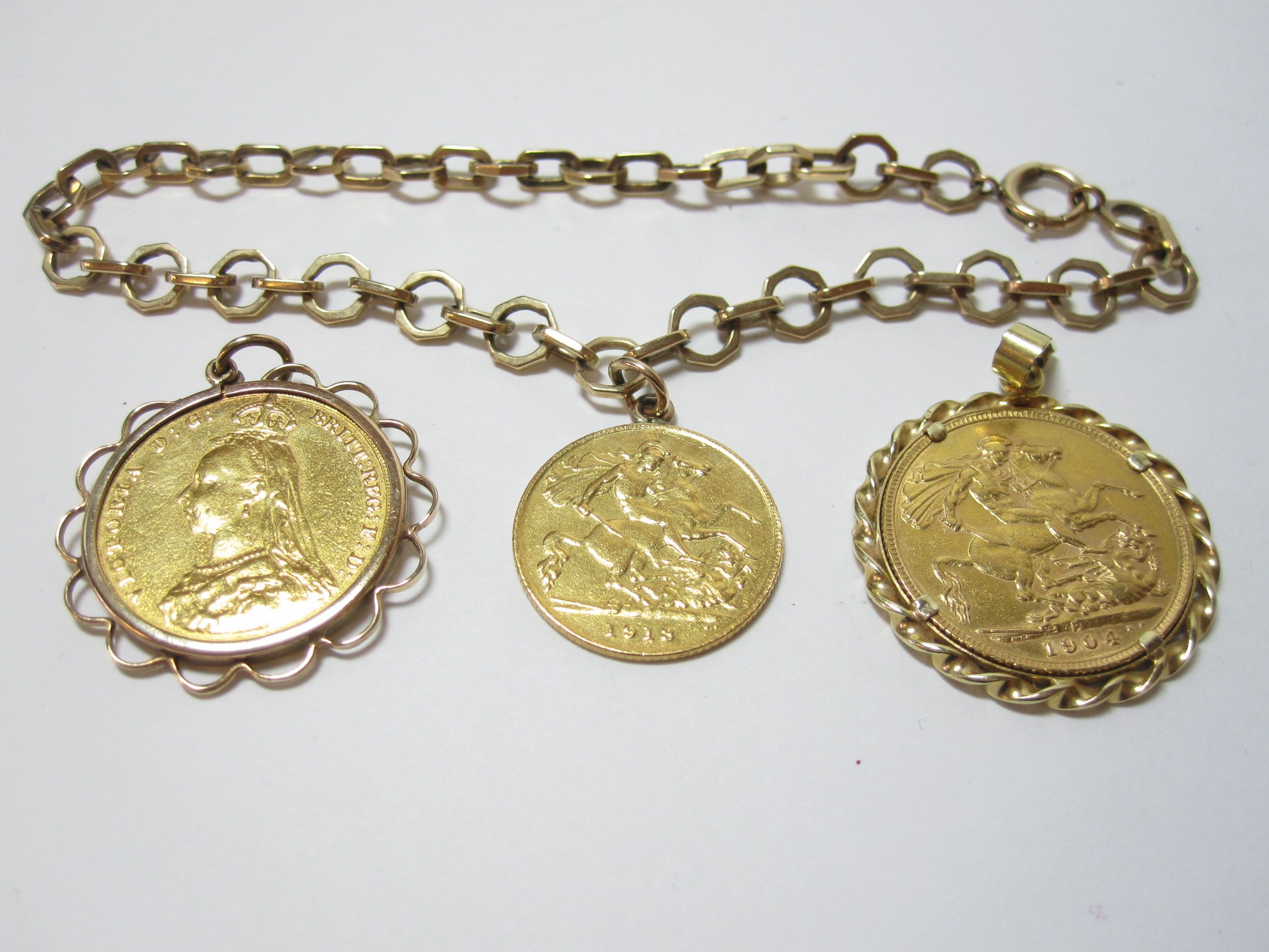 Bonhams : Two sovereign pendants and a half sovereign bracelet