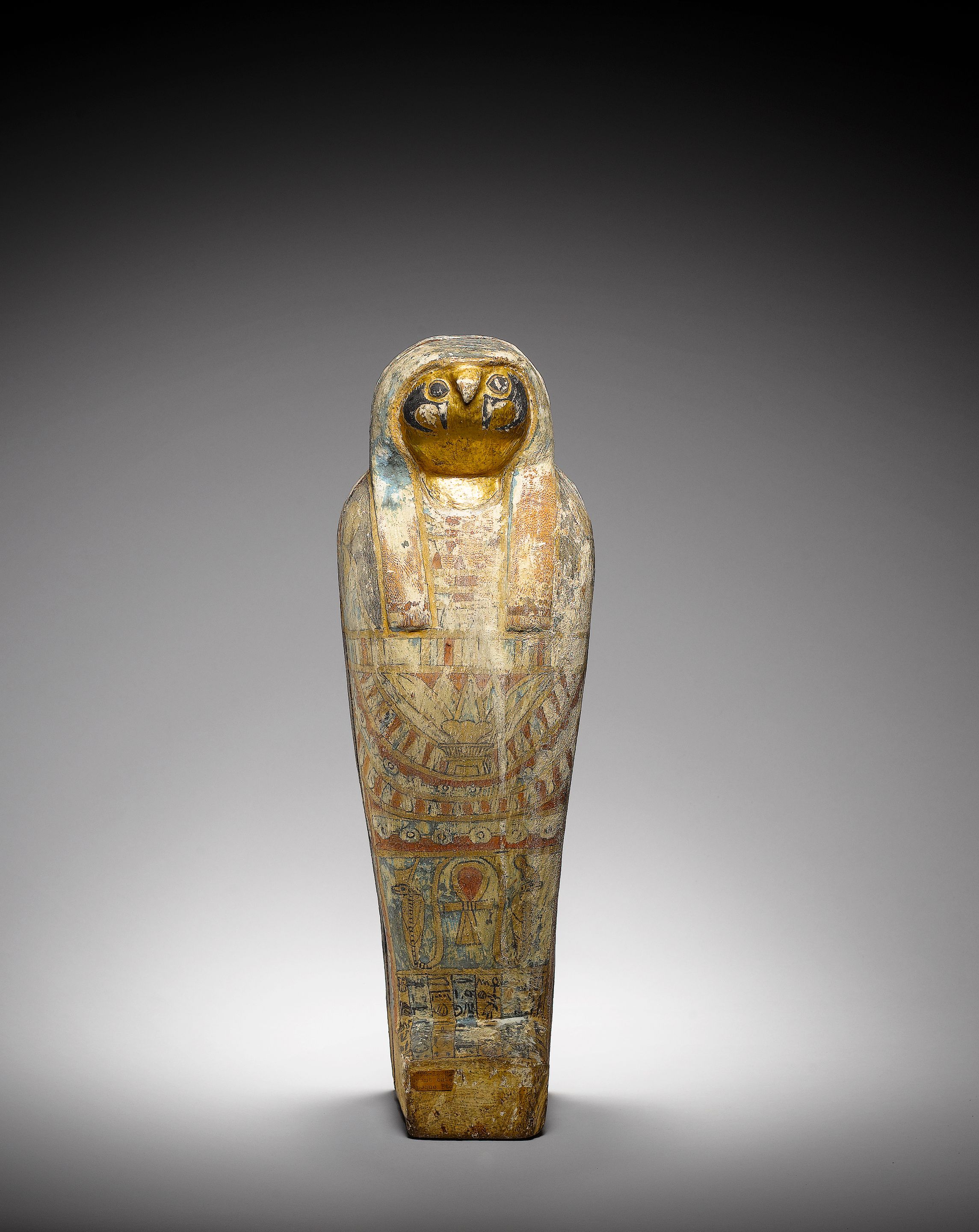 Bonhams : An Egyptian polychrome wood falcon sarcophagus