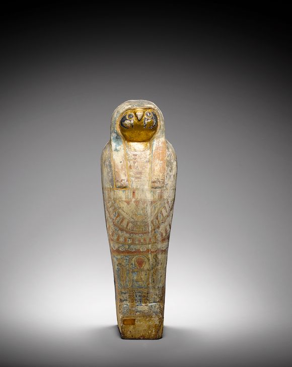 Bonhams : An Egyptian polychrome wood falcon sarcophagus