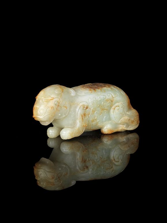 Bonhams : A pale green and russet jade carving of a bixie Ming Dynasty