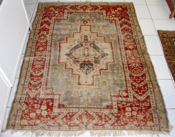 Bonhams : A Turkish rug,with central medallion on an ivory coloured ...