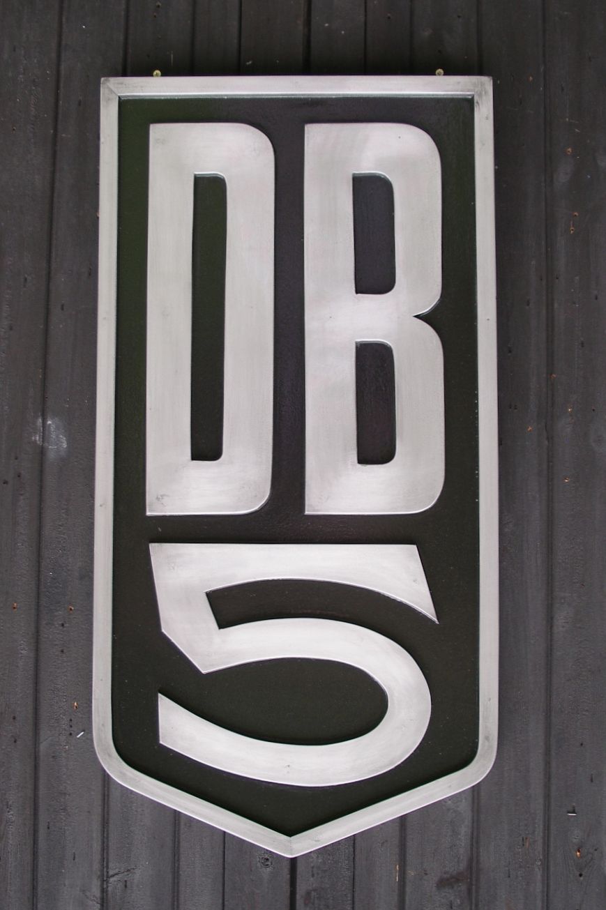 Bonhams Cars : An Aston Martin DB5 emblem,