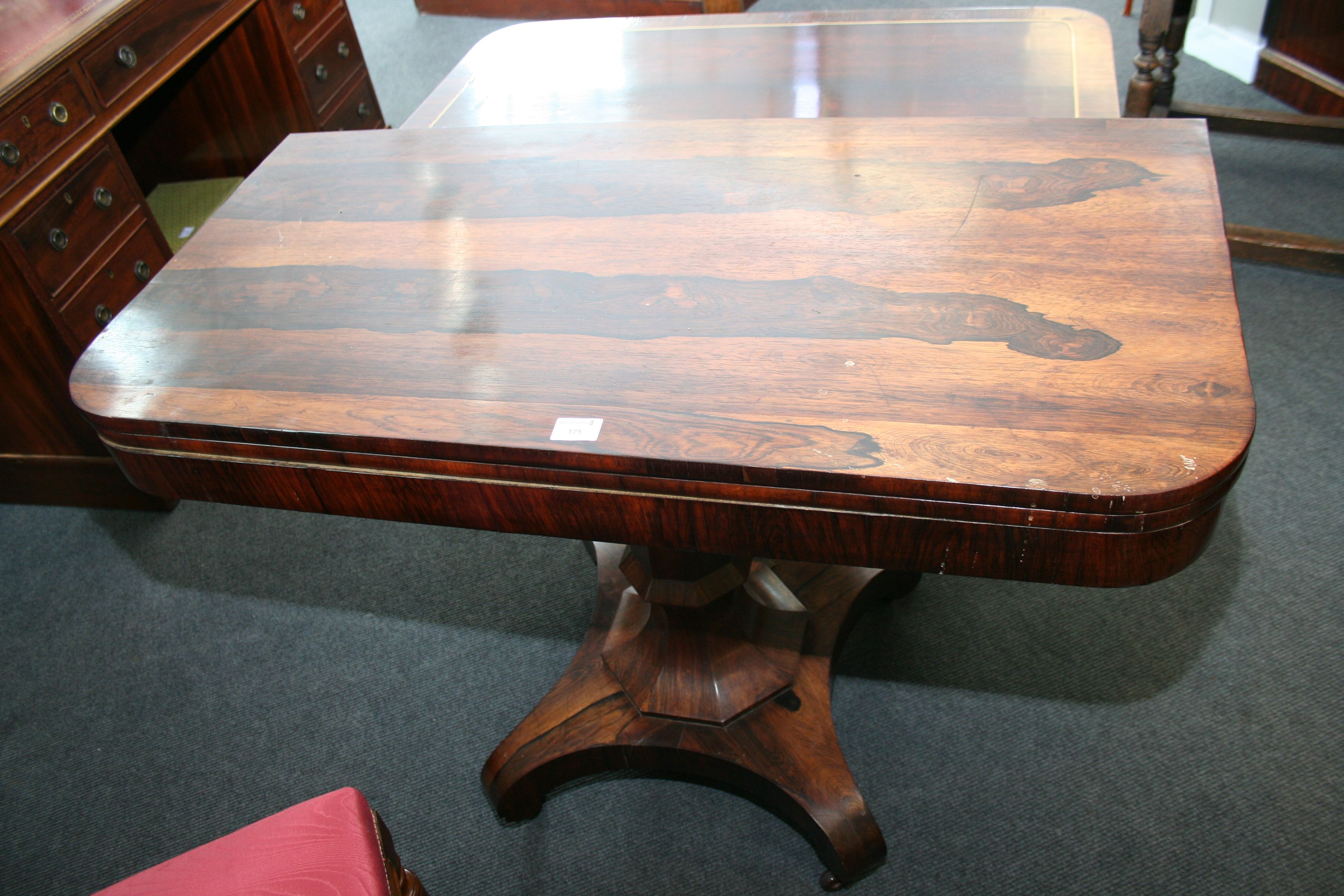 Bonhams : An early 19th century swivel action fold over rosewood tea table