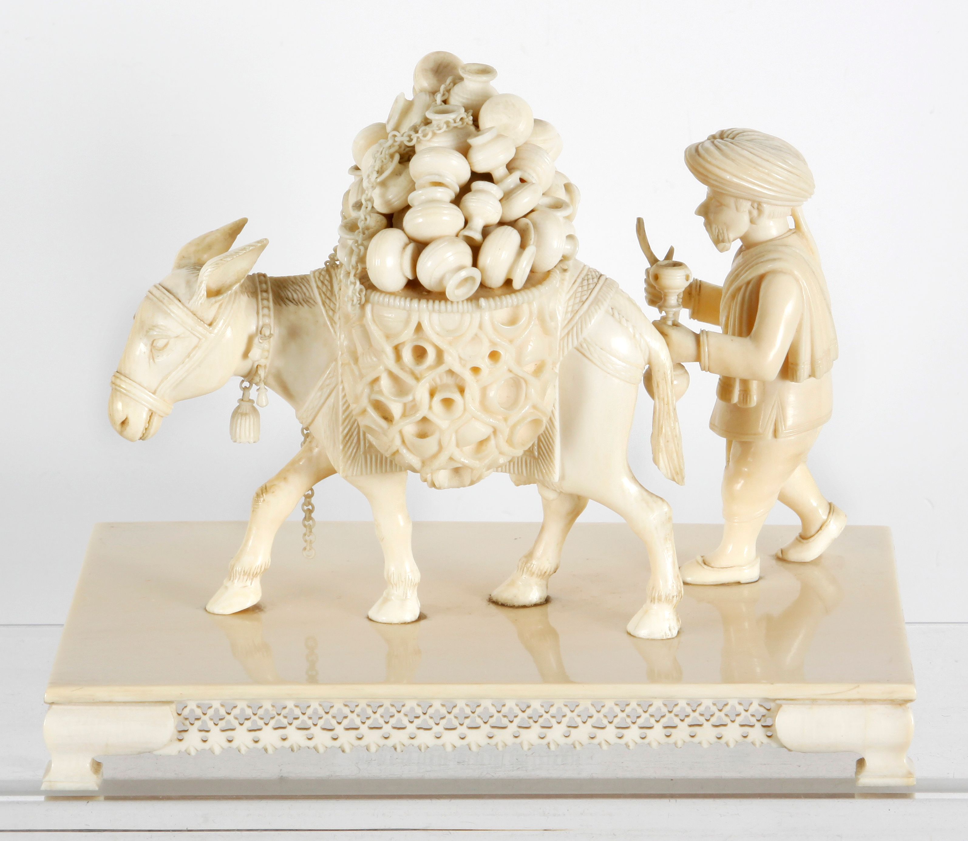 Bonhams : An Indian ivory carving Of a pedlar walking behind his mule ...