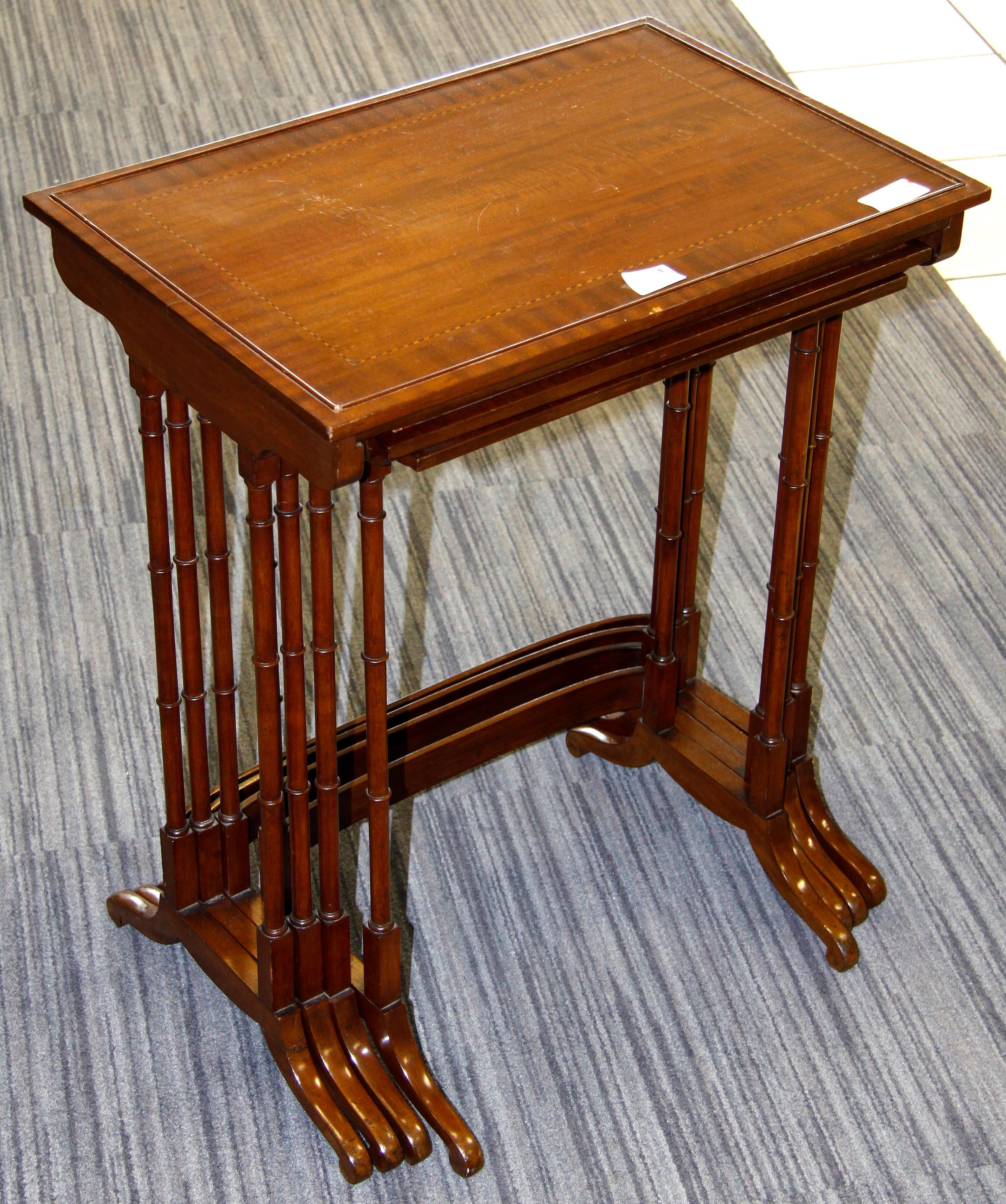 Bonhams : A nest of Edwardian mahogany and crossbanded quartetto tables