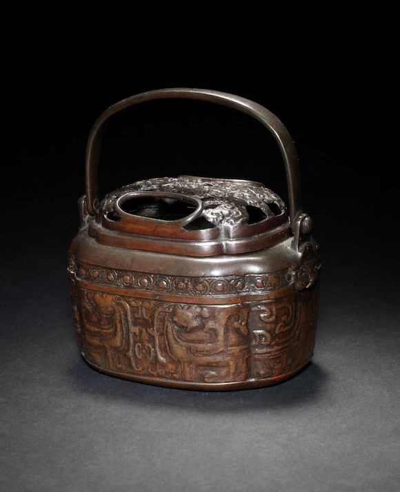 Bonhams : A bronzed metal hand warmer
