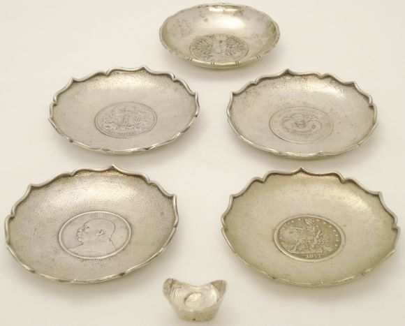 Bonhams : A set of four white metal coin dishes and another Late 19th ...