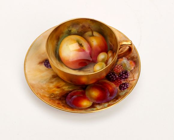 Bonhams : A small Royal Worcester fruit painted matched teacup cup and saucer, painted by Hilda ...