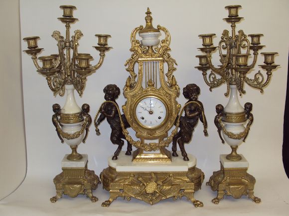 Bonhams : A reproduction gilt metal mantel clock garniture