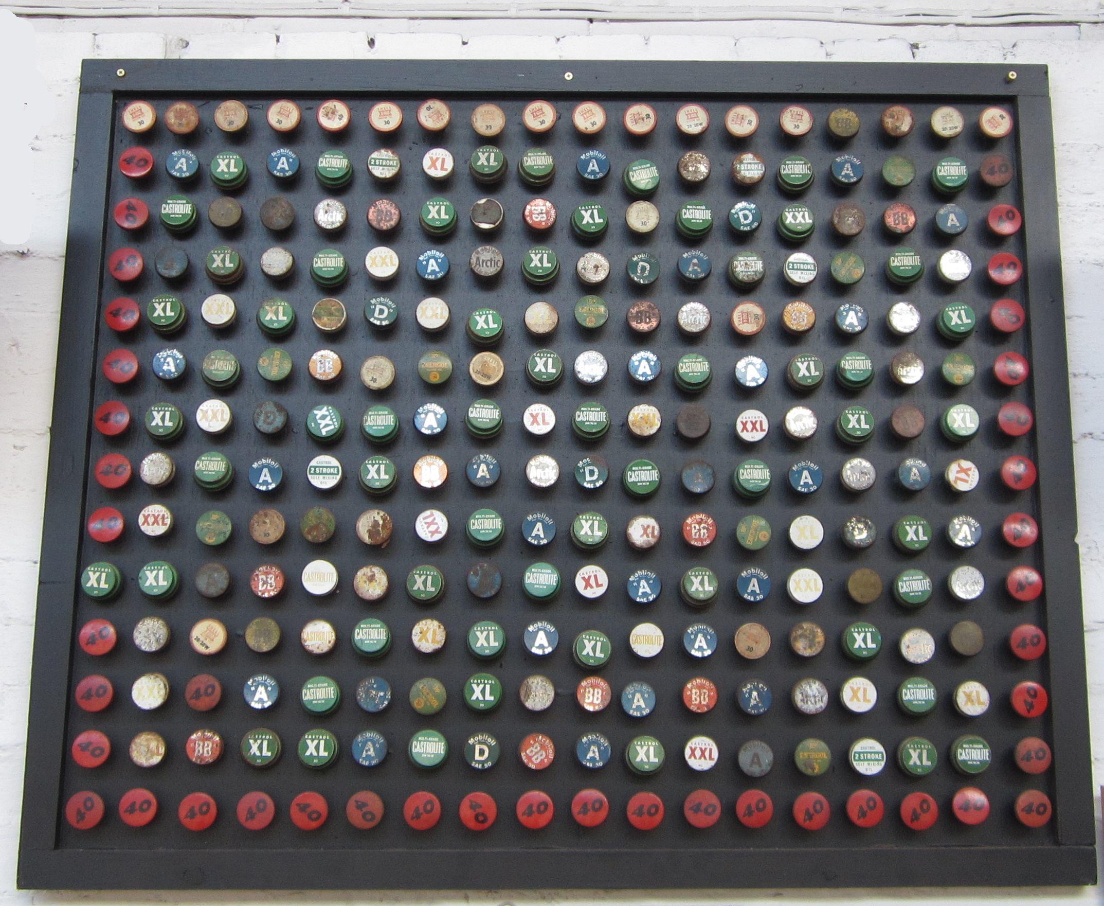 Bonhams Cars : A large framed display of assorted oil bottle caps,