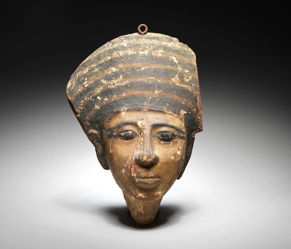 Bonhams : An Egyptian wood gesso-painted mummy mask