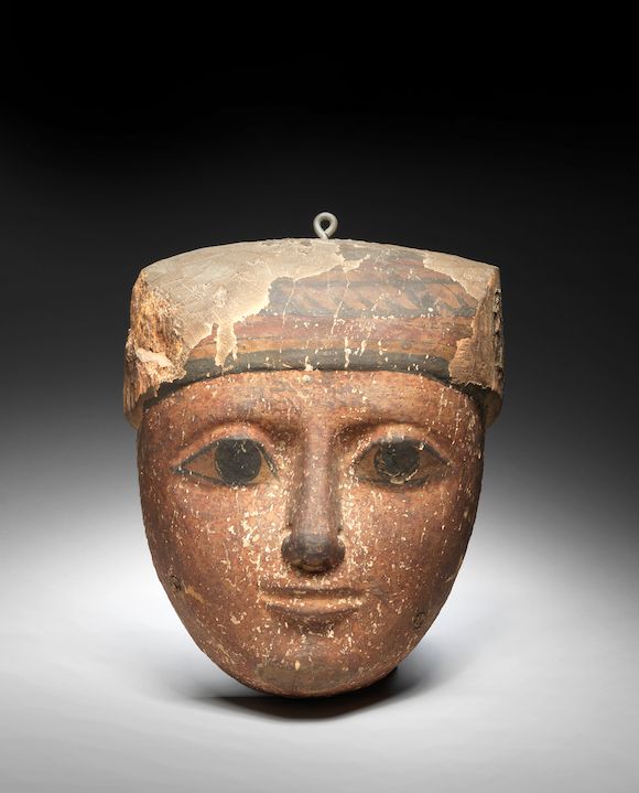 Bonhams : An Egyptian wood gesso-painted mummy mask