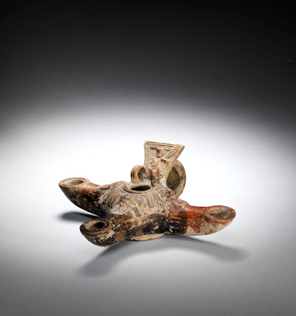 Bonhams : A Roman terracotta red slip ware oil lamp