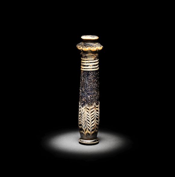 Bonhams : An Egyptian core-formed glass kohl bottle