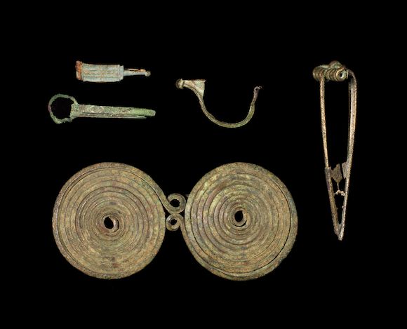 Bonhams : A Geometric European bronze spectacle fibula and four Roman ...