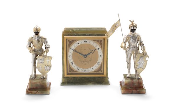 Bonhams : A pair of silver clock garnitures, modelled as knights with ...