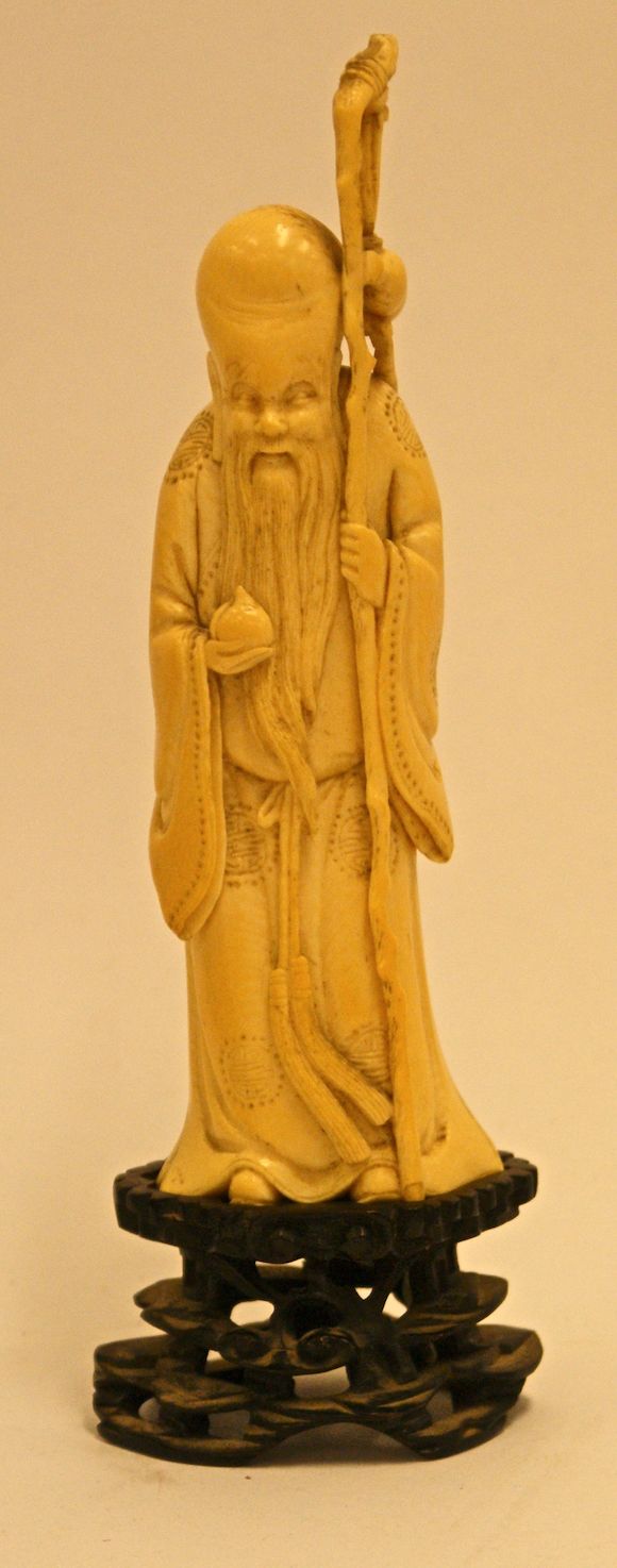 Bonhams : A Chinese ivory carving of the deity Shou, holding a staff ...