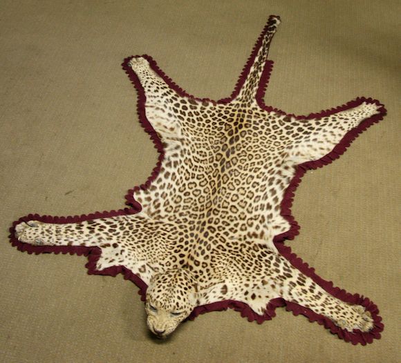 Bonhams : A leopard skin rug with full mount headBy 'GLG'