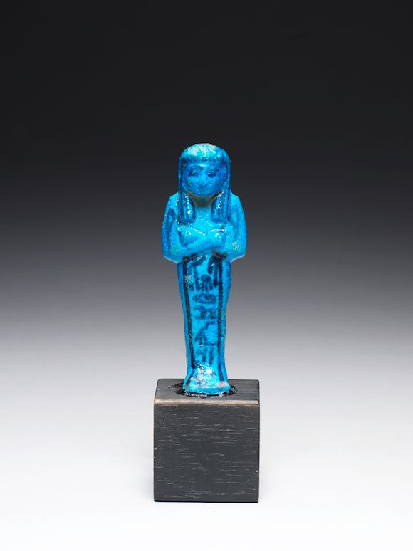 Bonhams : An Egyptian bright blue glazed composition shabti for Tayuheret