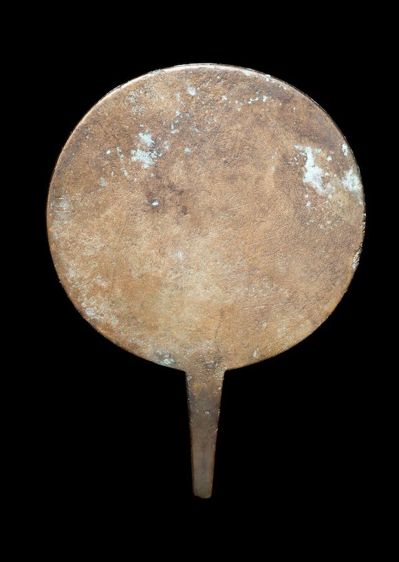 Bonhams : An Egyptian copper-alloy mirror