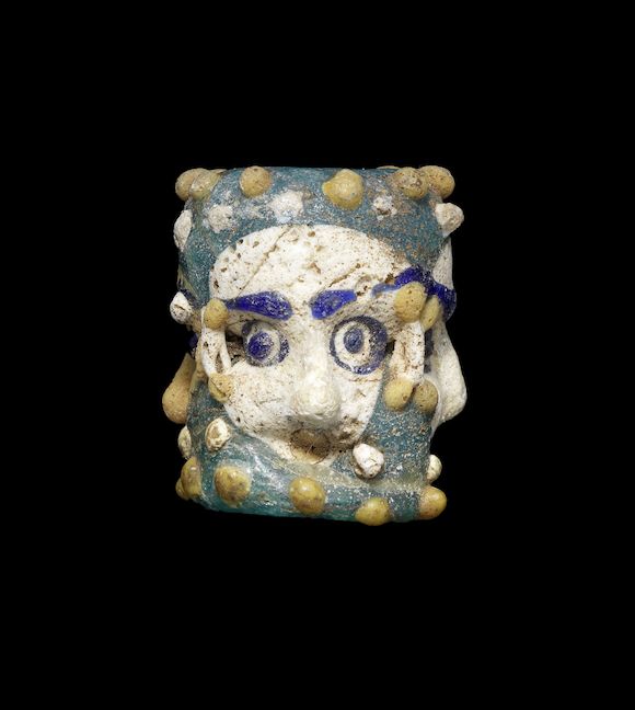 Bonhams : An Eastern Mediterranean core-formed triple-headed face bead