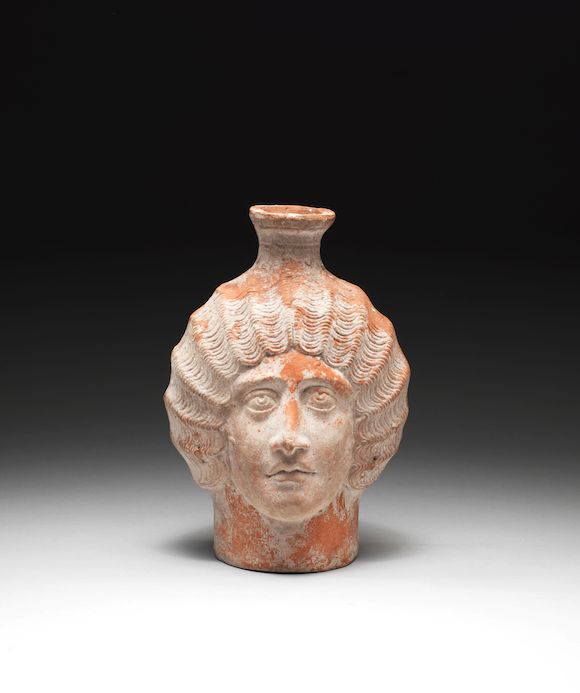 Bonhams : A Roman red slip ware plastic head jug