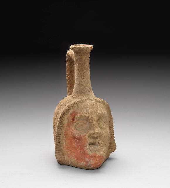 Bonhams : A Roman red slip ware pottery head flask