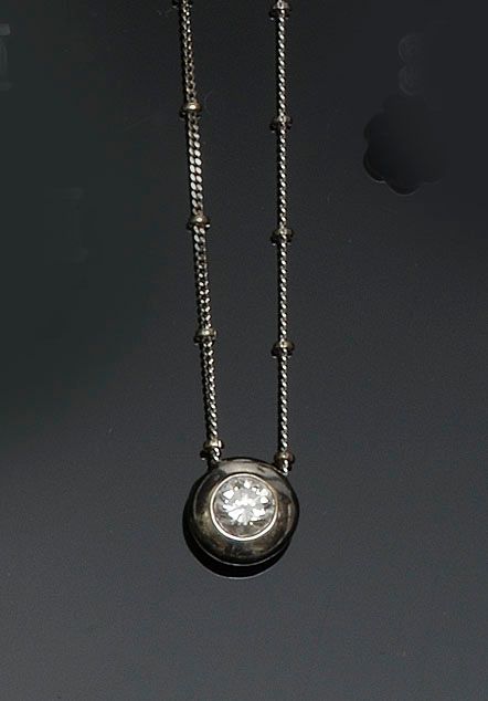 Bonhams : A diamond single stone pendant necklace