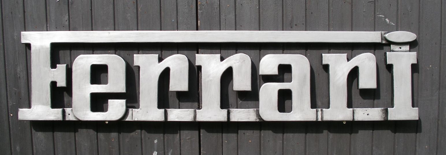 Bonhams Cars : A Ferrari script garage display emblem,