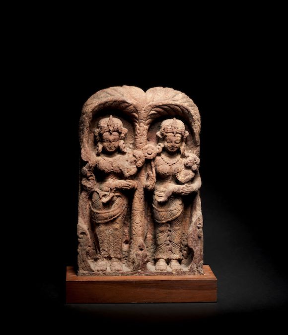 Bonhams : A pair of red sandstone Yakshi Figures holding infants ...