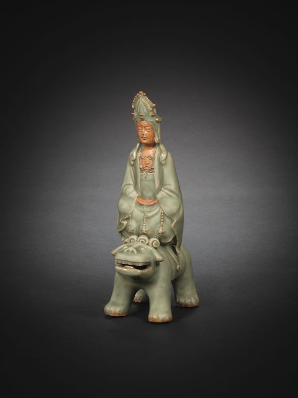 Bonhams : A celadon-glazed and biscuit figure of Guanyin on a lion 14th ...