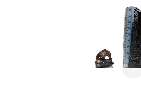 Bonhams : A wood netsuke of a kappa on a clam By Homin, Edo, 19th century