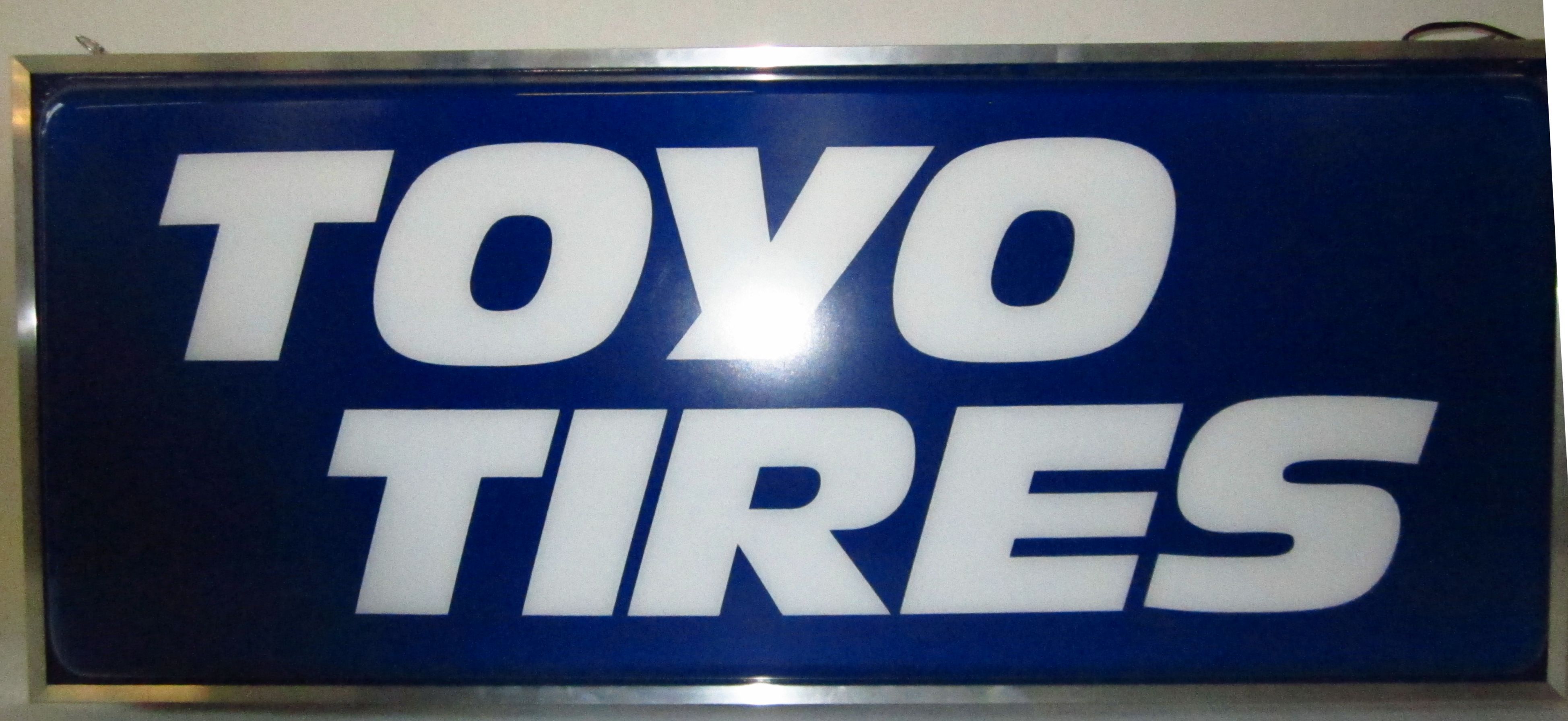 Bonhams Cars : A Toyo Tires sign,