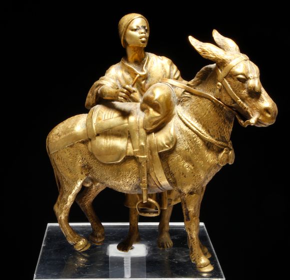 Bonhams : A bronze figure of an Arab vendor with a donkey