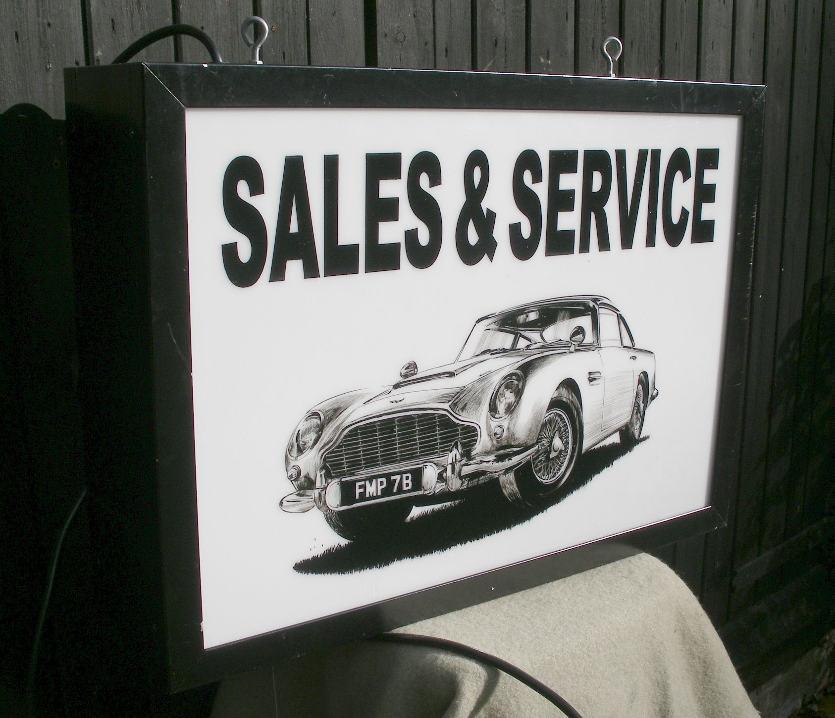 Bonhams Cars : An 'Aston Martin Sales and Service' light box,