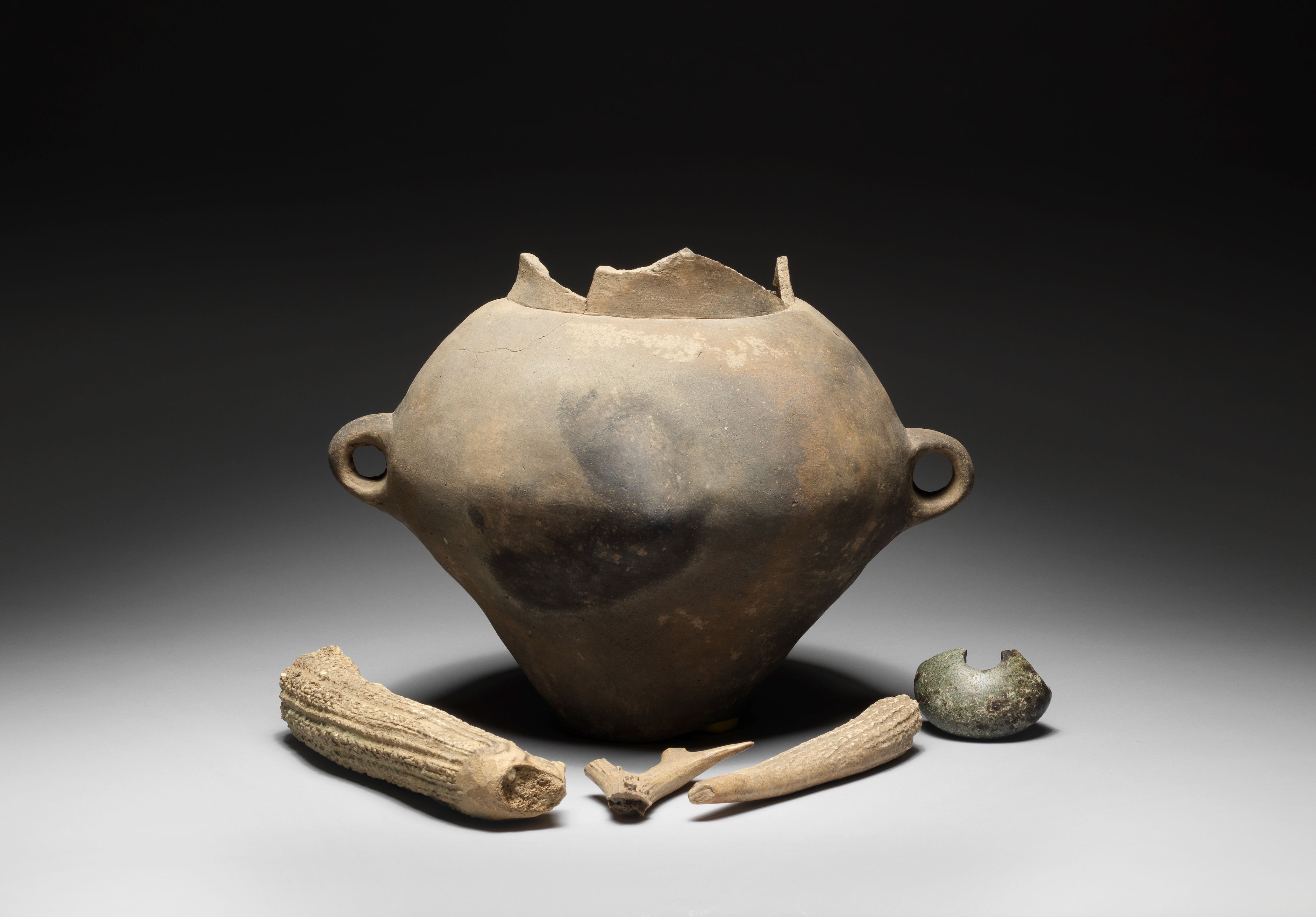 Bonhams : A Neolithic pottery urn with seven bone and antler implements, 8