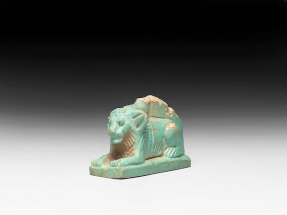 Bonhams : An Egyptian turquoise glazed composition lion