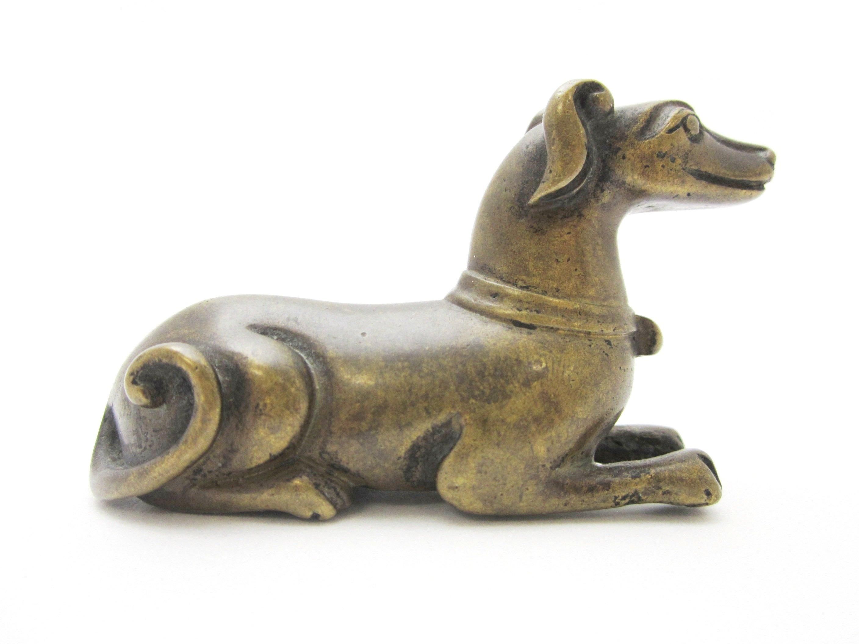 Bonhams : A bronze scroll weight 18th century