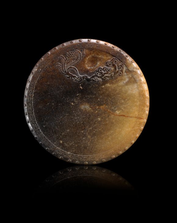 Bonhams : A russet jade shallow circular 'drum' inkstone Ming Dynasty