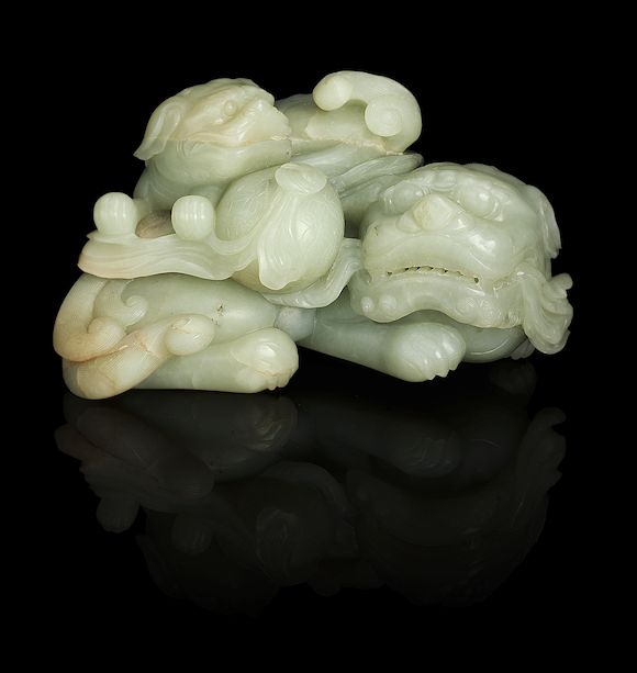 Bonhams : A superb large pale green jade group of a Buddhist lion and ...