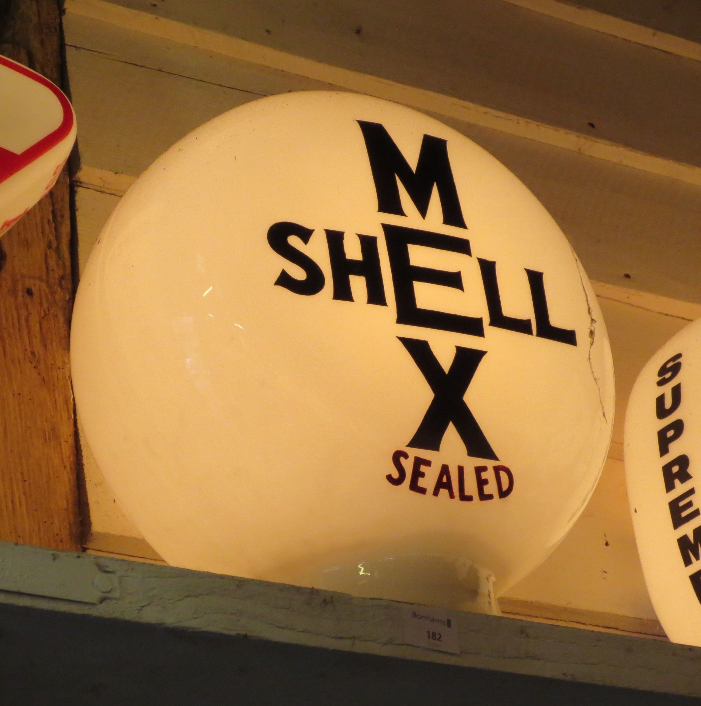 Bonhams Cars : A Sealed Shell Mex glass petrol pump globe,