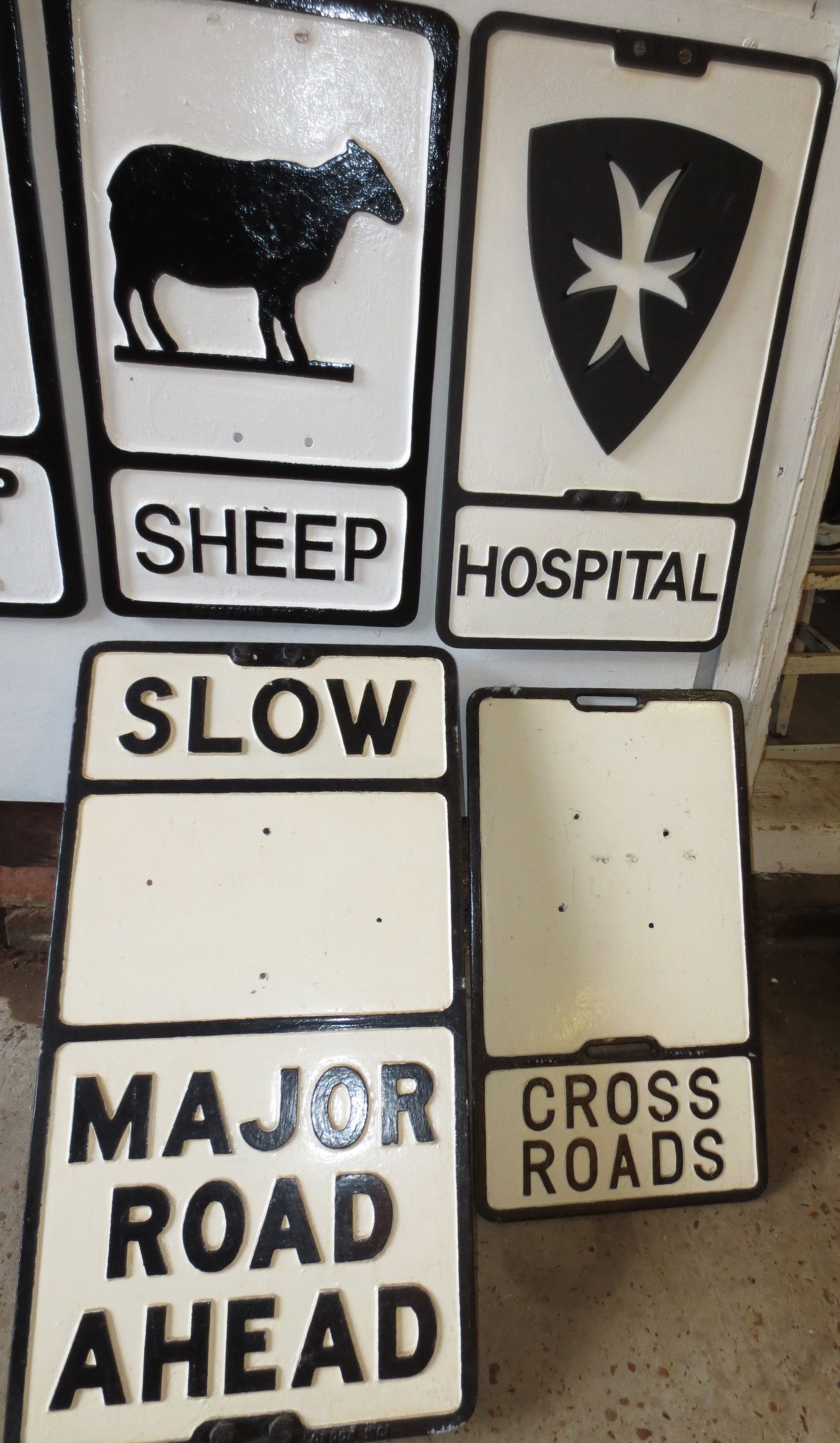 Bonhams Cars : Four cast metal road signs,