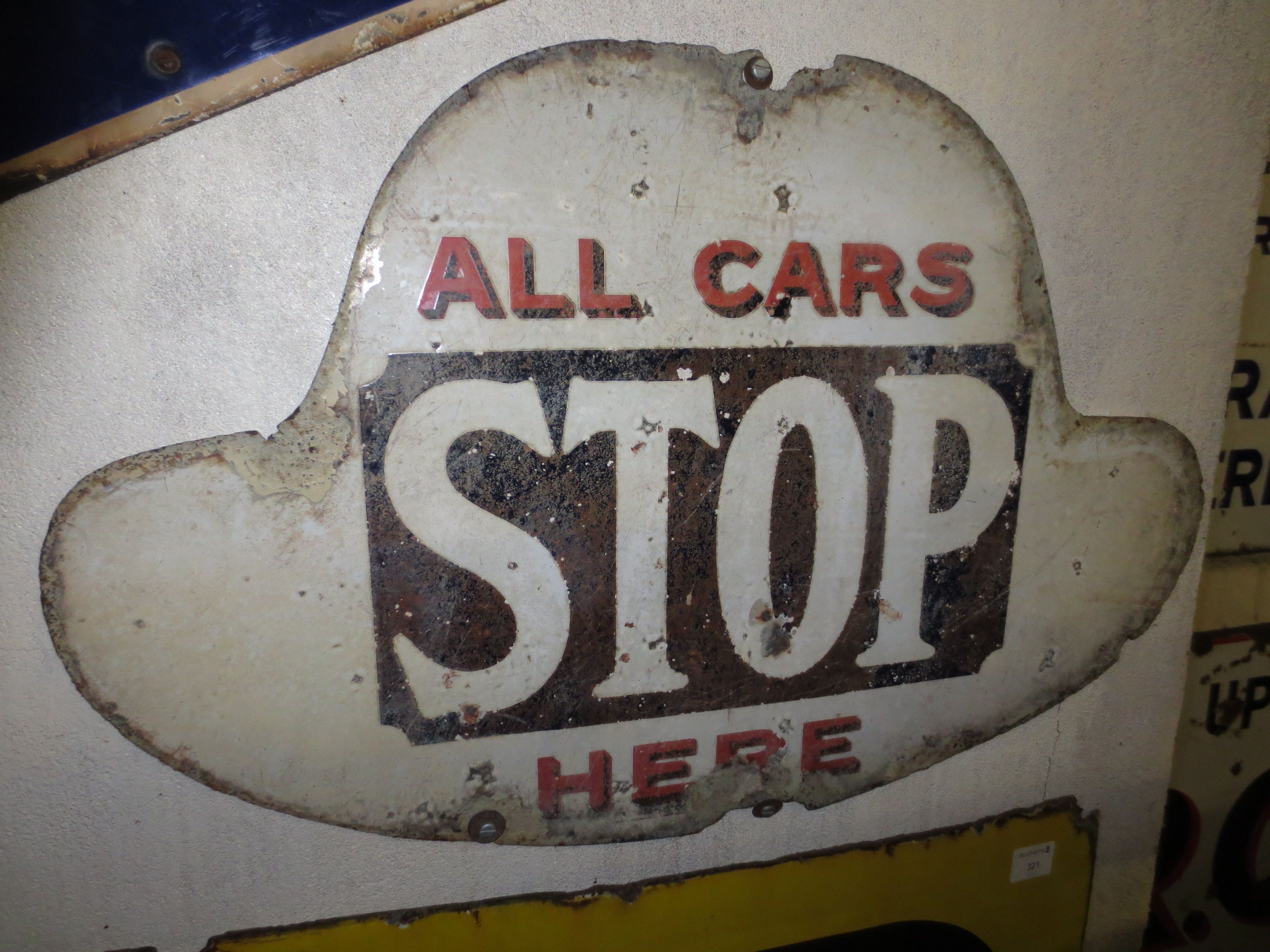 Bonhams Cars : An 'All Cars Stop Here', shaped enamel sign,