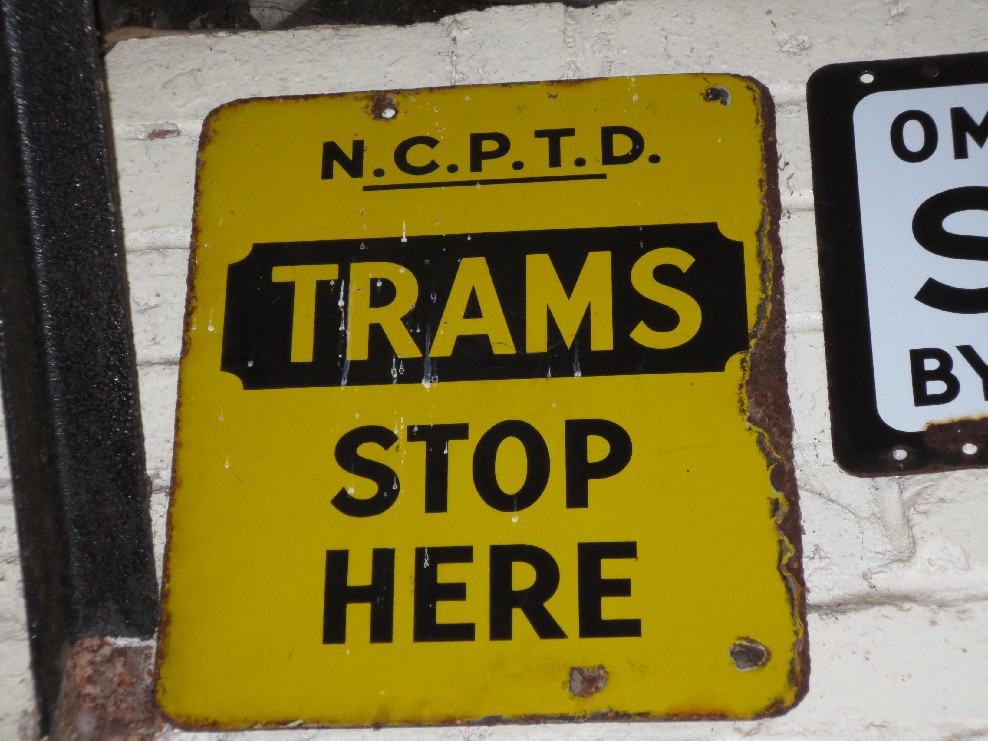 Bonhams Cars : An 'N.C.P.T.D. Trams Stop Here' enamel sign,